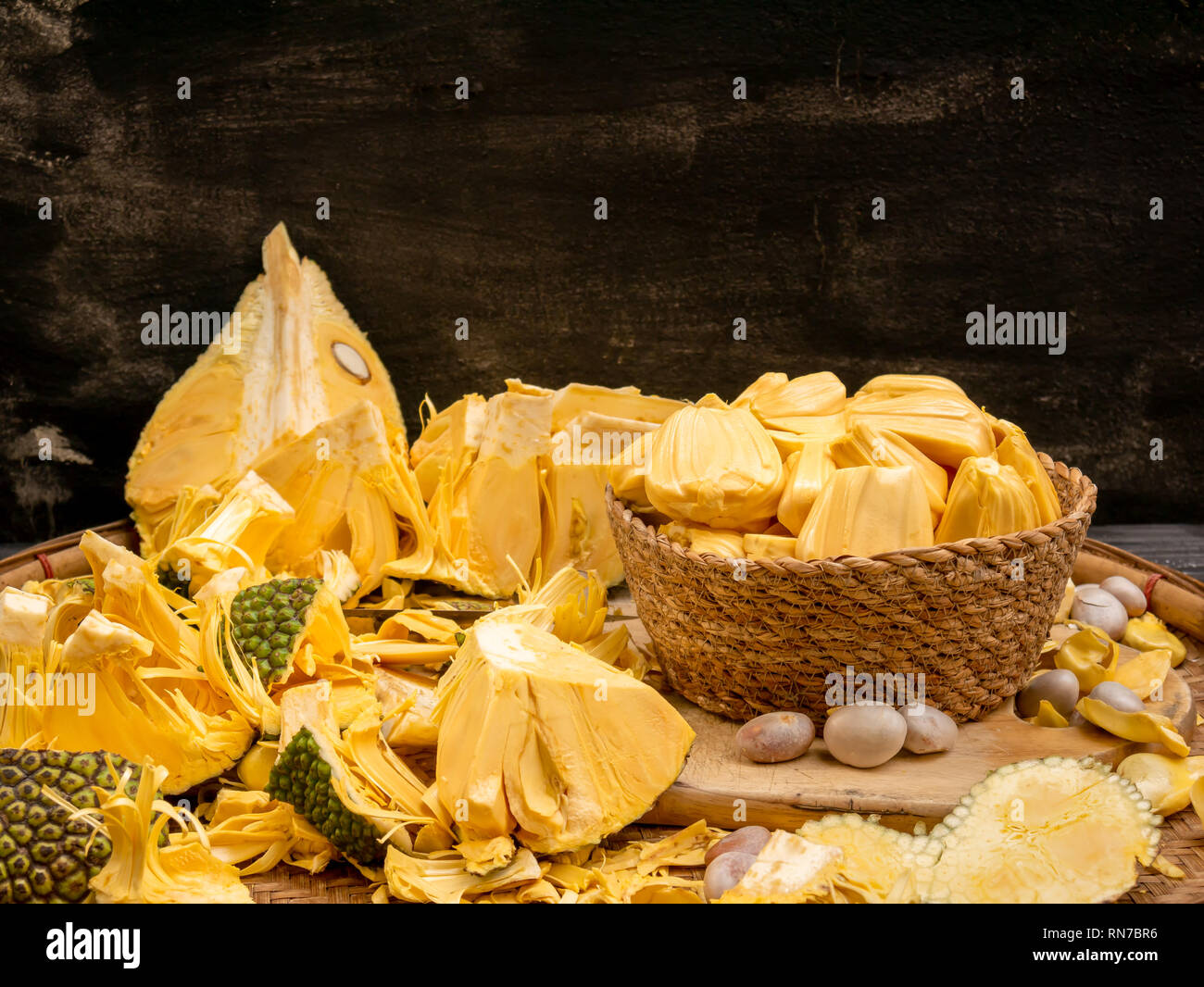Peeled jackfruit in weaving basket with seed and shell on threshing ...
