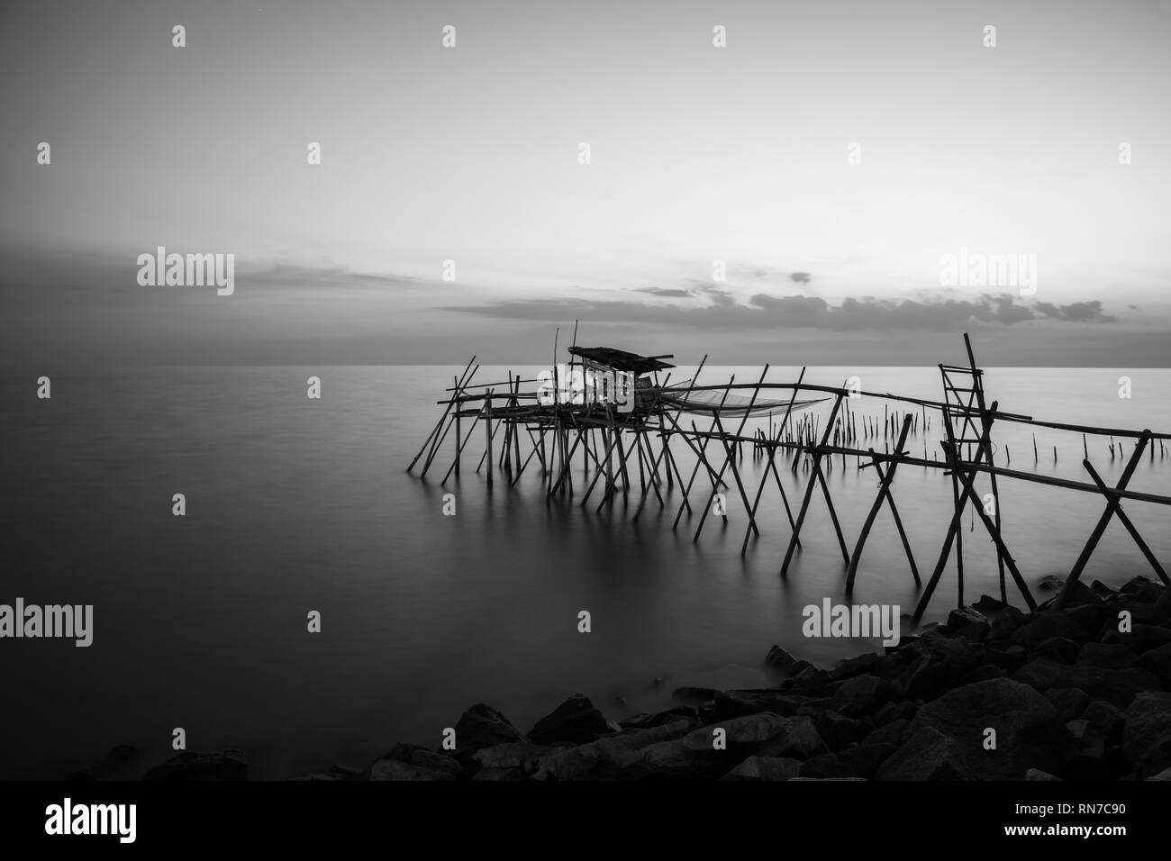 wooden Jetty with the rocky seaside during blue hour. Long Exposure ...