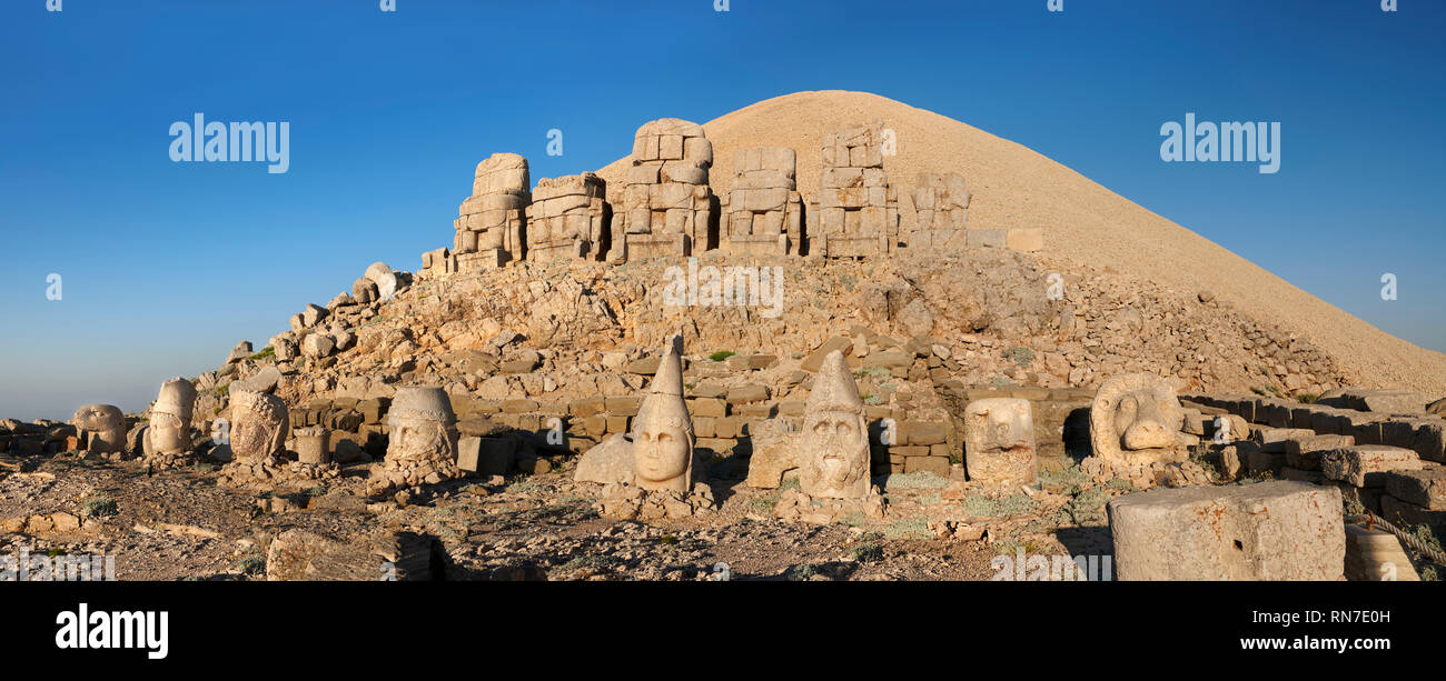 Statue heads with headless seated statues in front of the stone pyramid ...