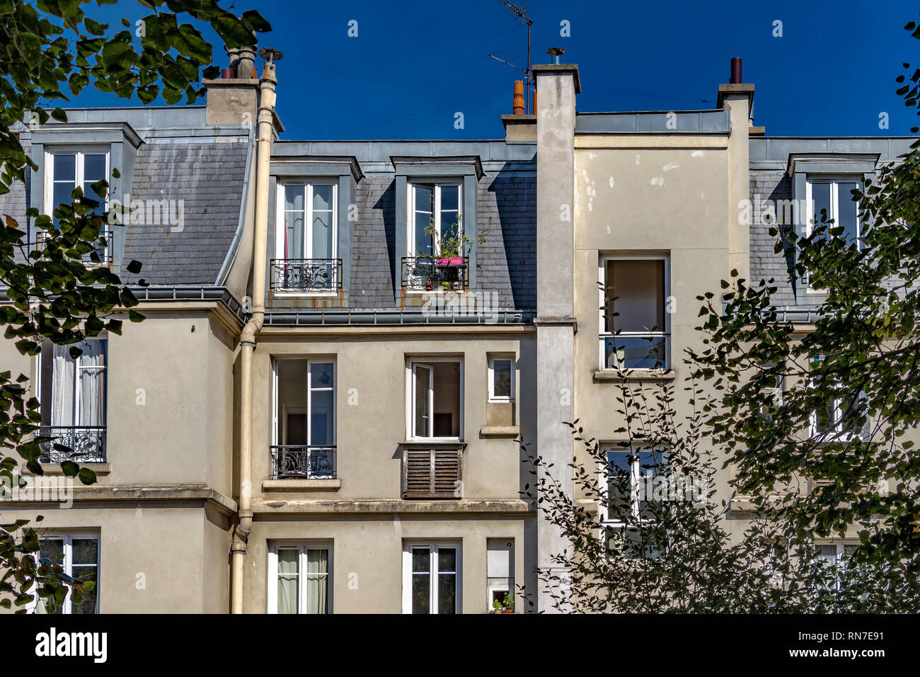 Paris building with attic rooms, tall chimney stacks and grey slate ...