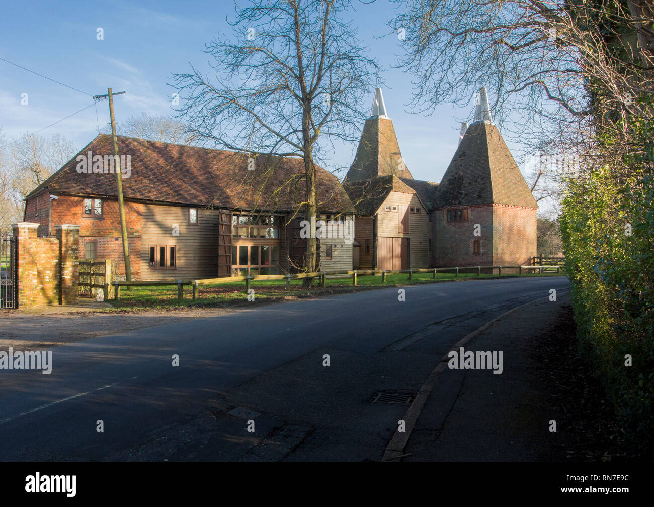 A converted barn and square oast house in a village in Kent, UK Stock ...