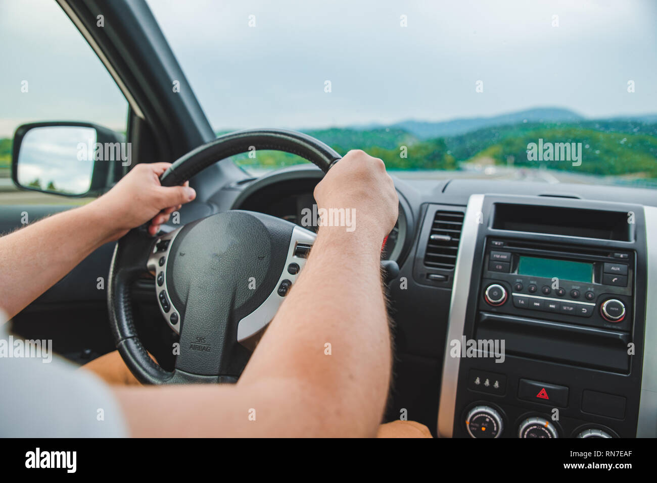 man driving car by speedway. road trip Stock Photo - Alamy