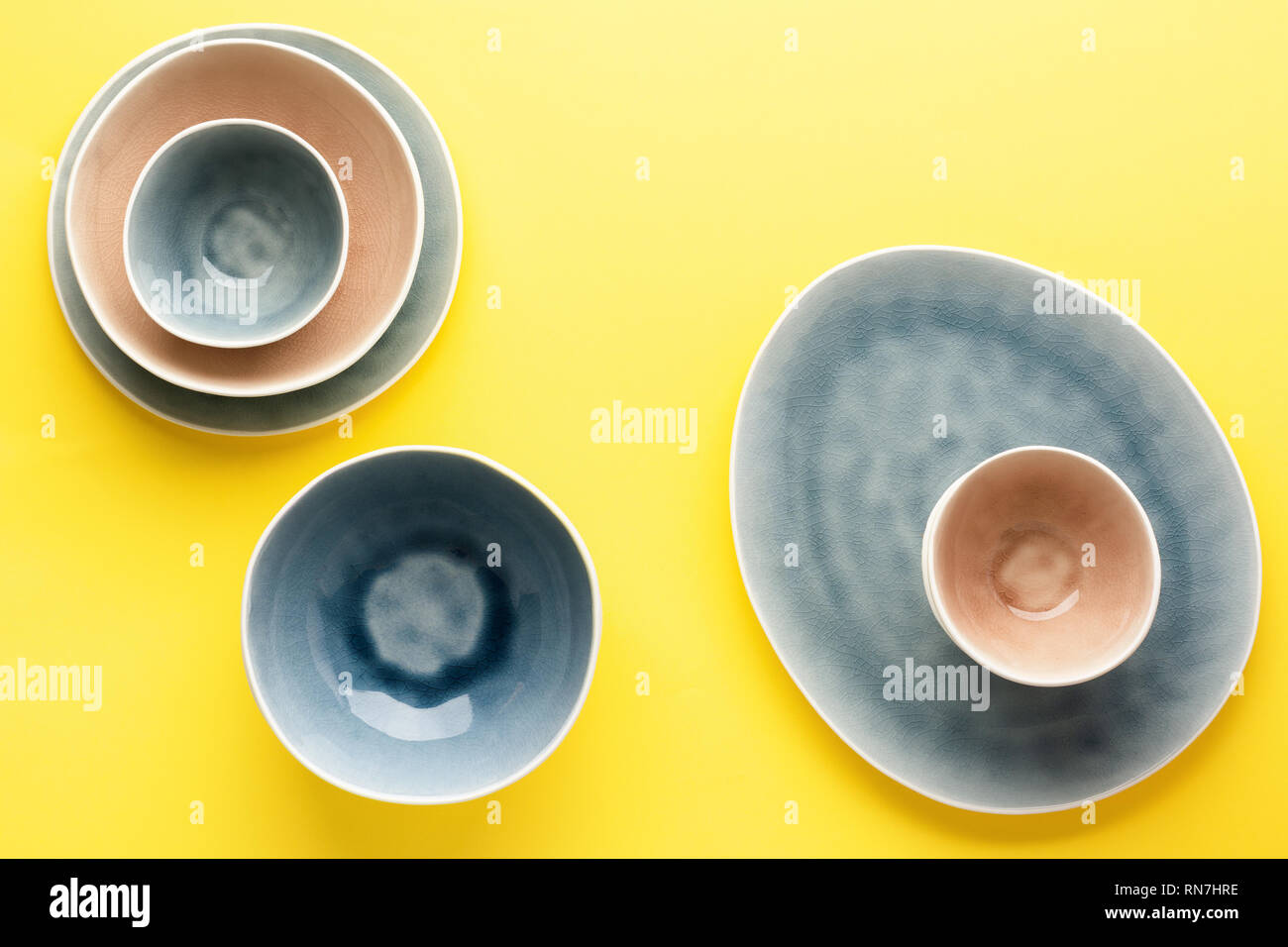 Beautiful blue, grey, beige dinnerware, plates bowls on yellow ...