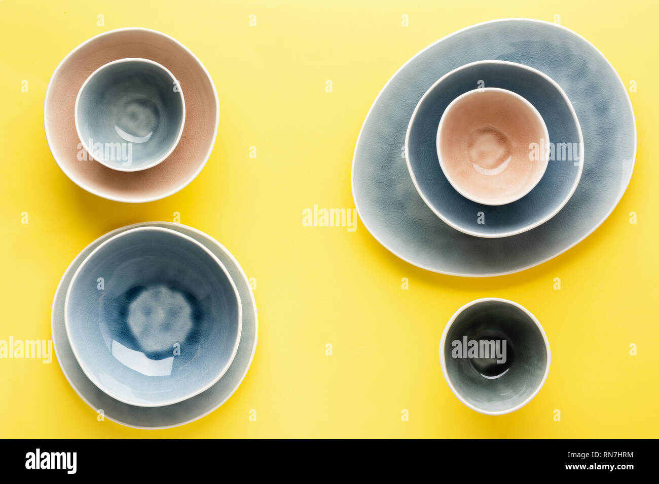 Beautiful blue, grey, beige dinnerware, plates bowls on yellow ...