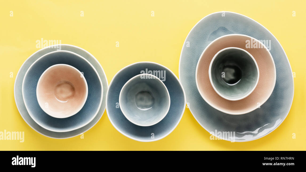 Beautiful blue, grey, beige dinnerware, plates bowls on yellow ...