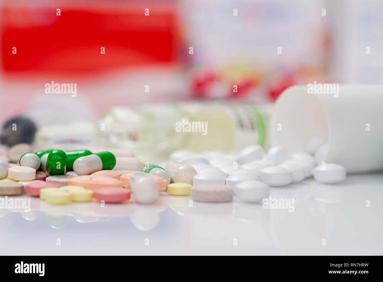 A mix of different medicines, colorful tablets, pills, capsules on ...