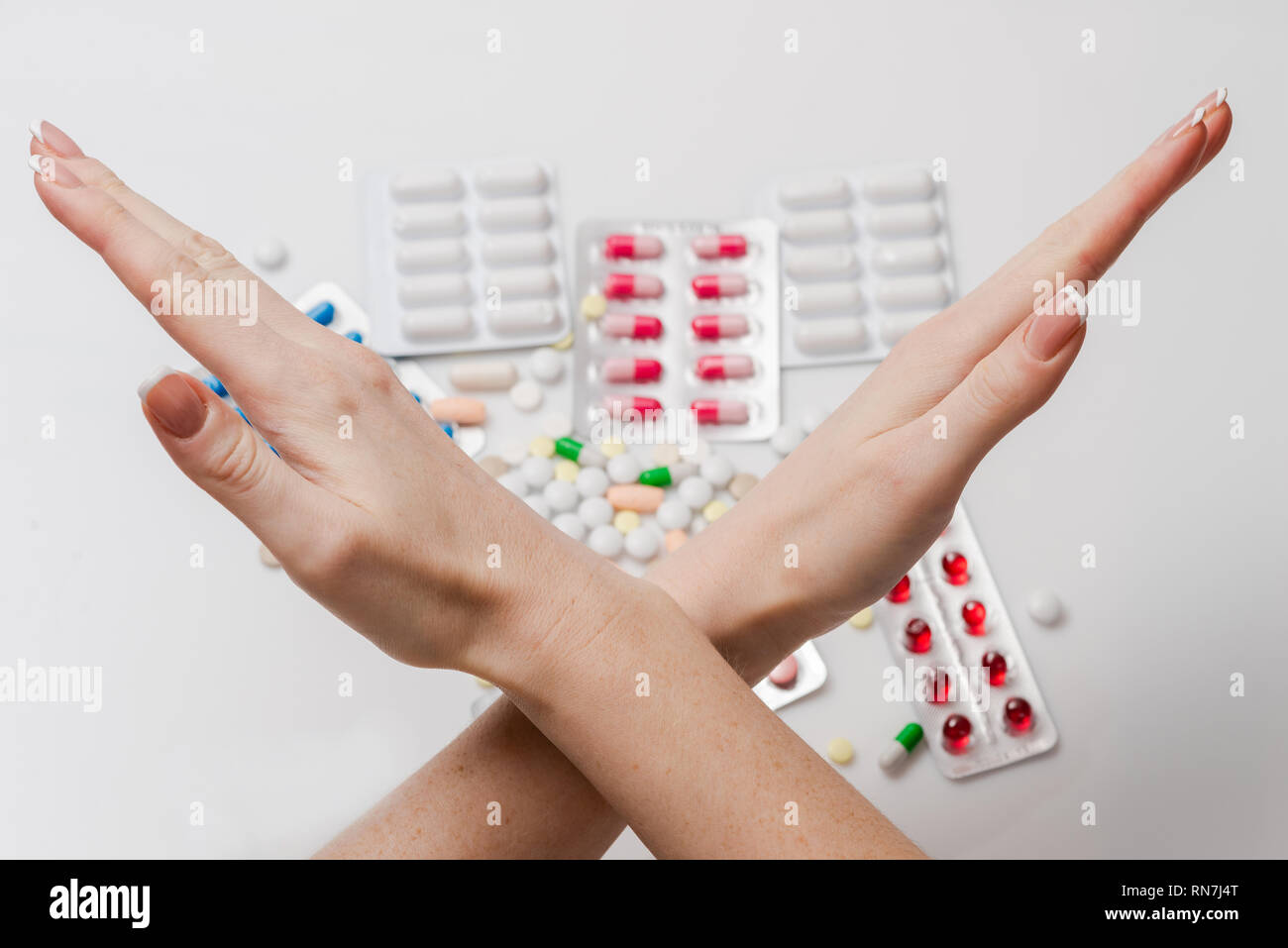 Female hands in cross refuse medical drugs. Prohibited hand gesture ...