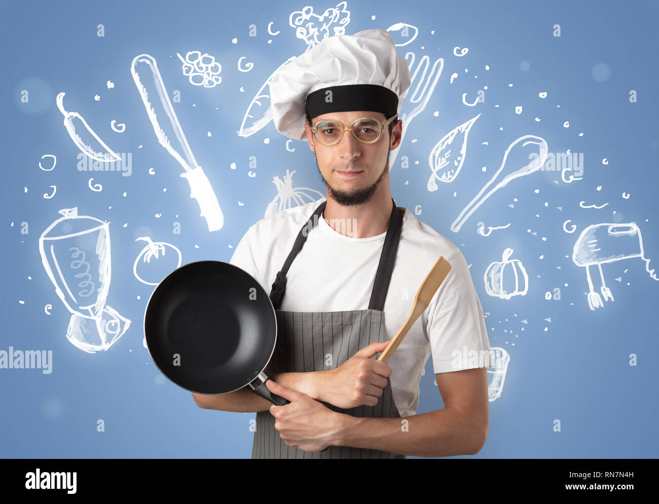Young cook with kitchen instruments and drawn recipe concept on ...