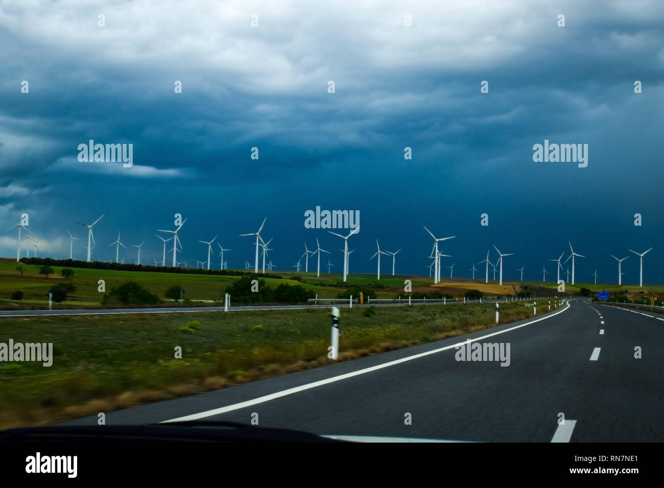 Windmill turbines power plant for electricity generation close to road ...