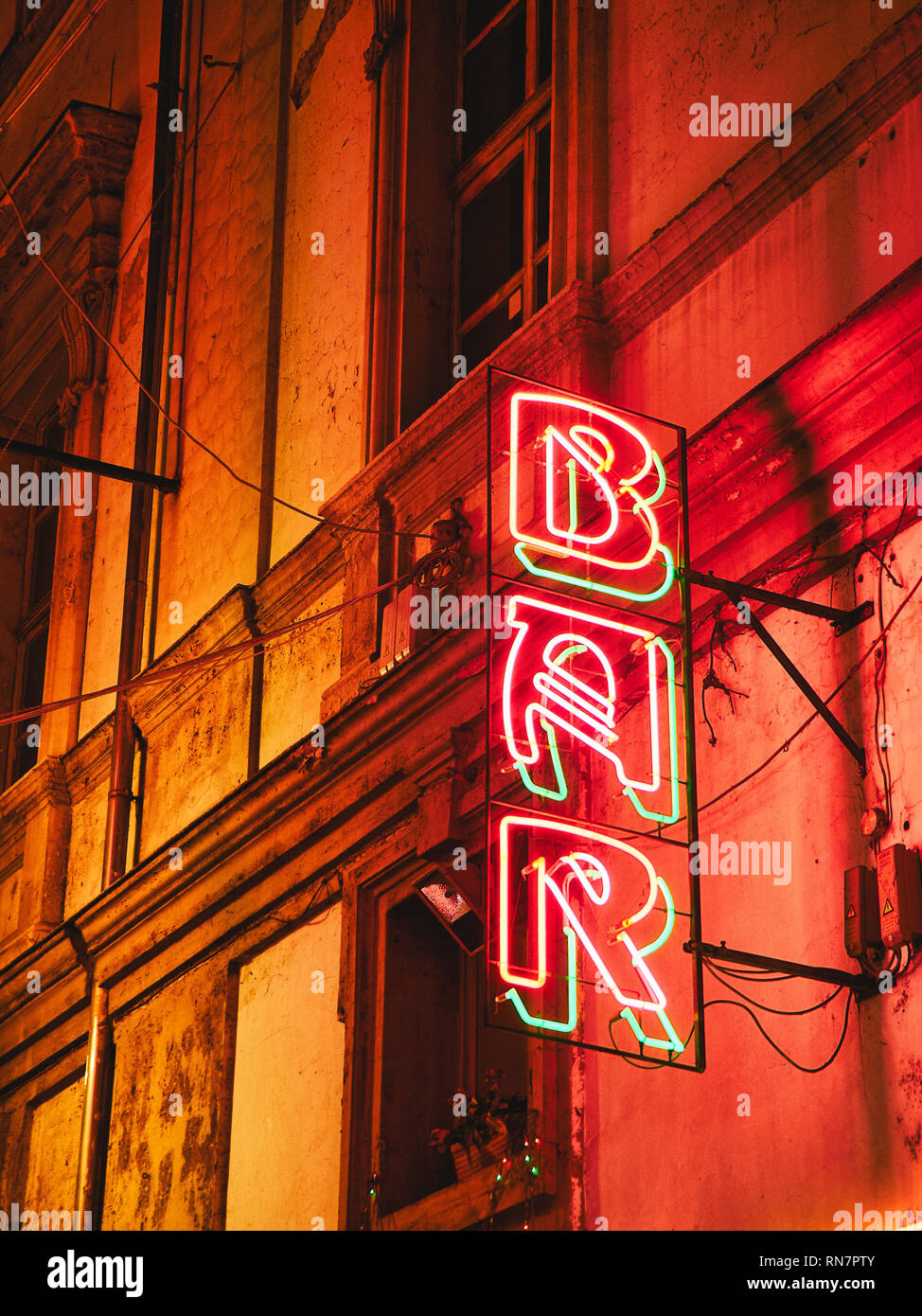 Bar Neon signboard in an European street at night Stock Photo - Alamy