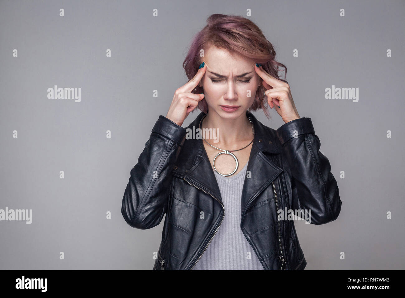 Headache. Portrait of woman with short hairstyle and makeup in casual ...