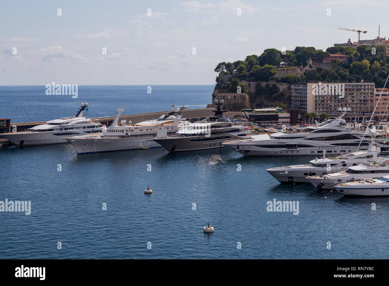 View from the Yacht Club de Monaco at super yachts docked in the port ...