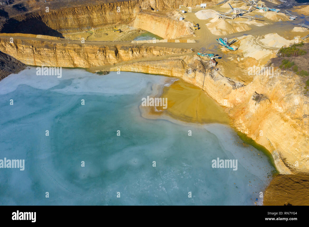 Aerial view of opencast mining quarry with lots of machinery ...