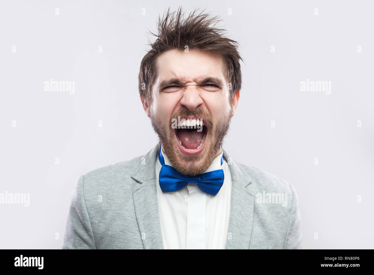 Closeup portrait of anger crazy handsome bearded man in casual grey ...