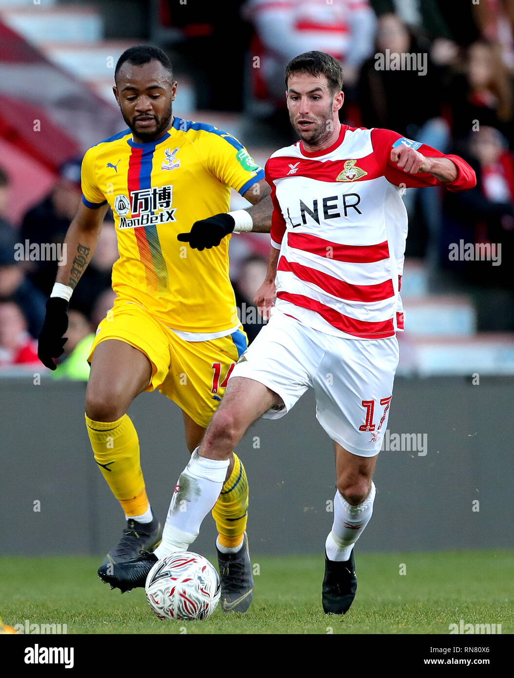Crystal Palace's Jordan Ayew (left) and Doncaster Rovers' Matty Blair ...