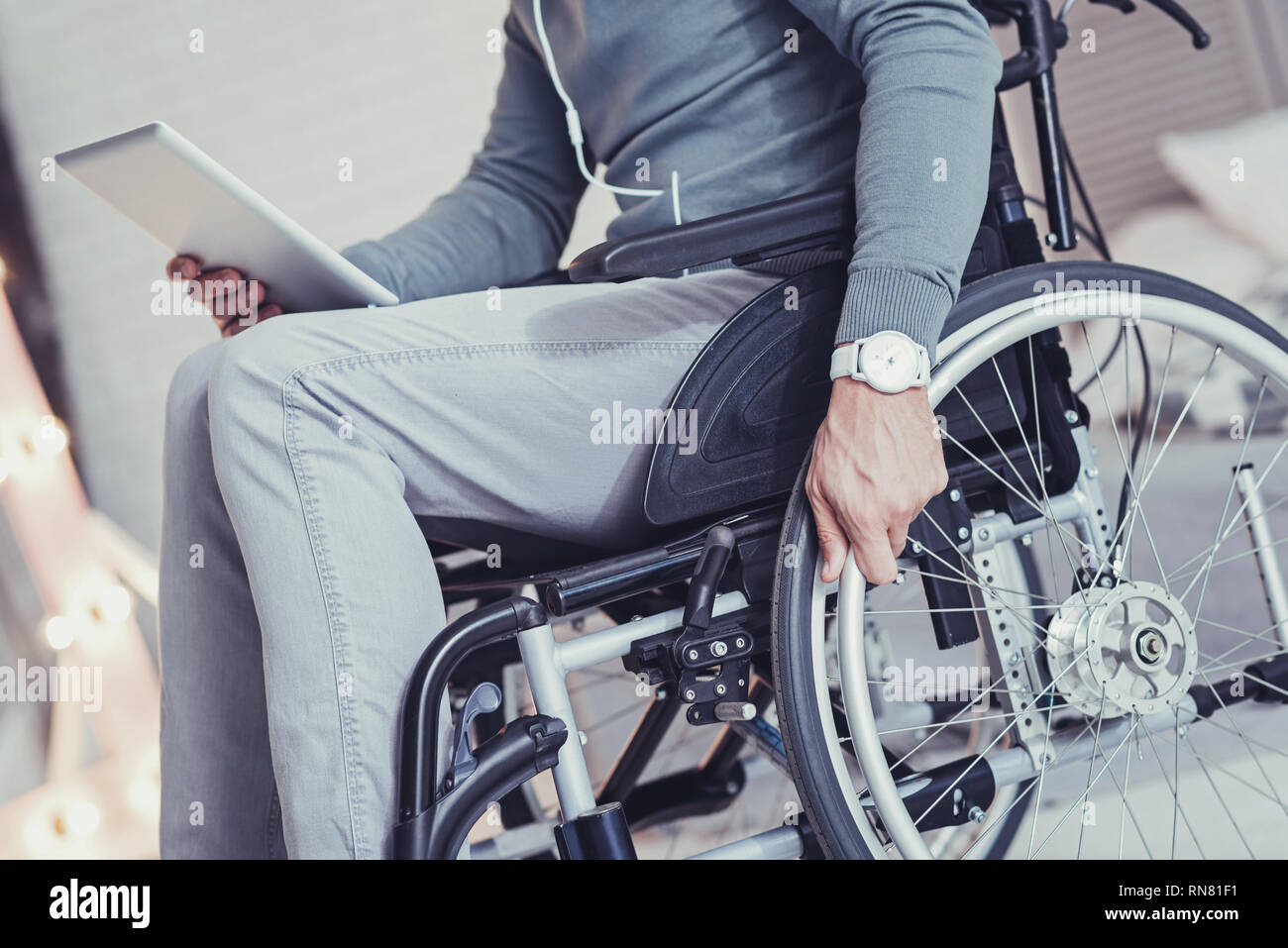 Physical disability. Nice young man using modern gadgets while moving ...