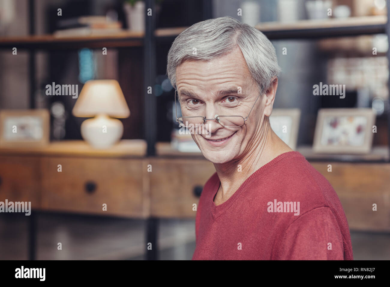 Curious man. Handsome senior man smiling and looking curious while ...