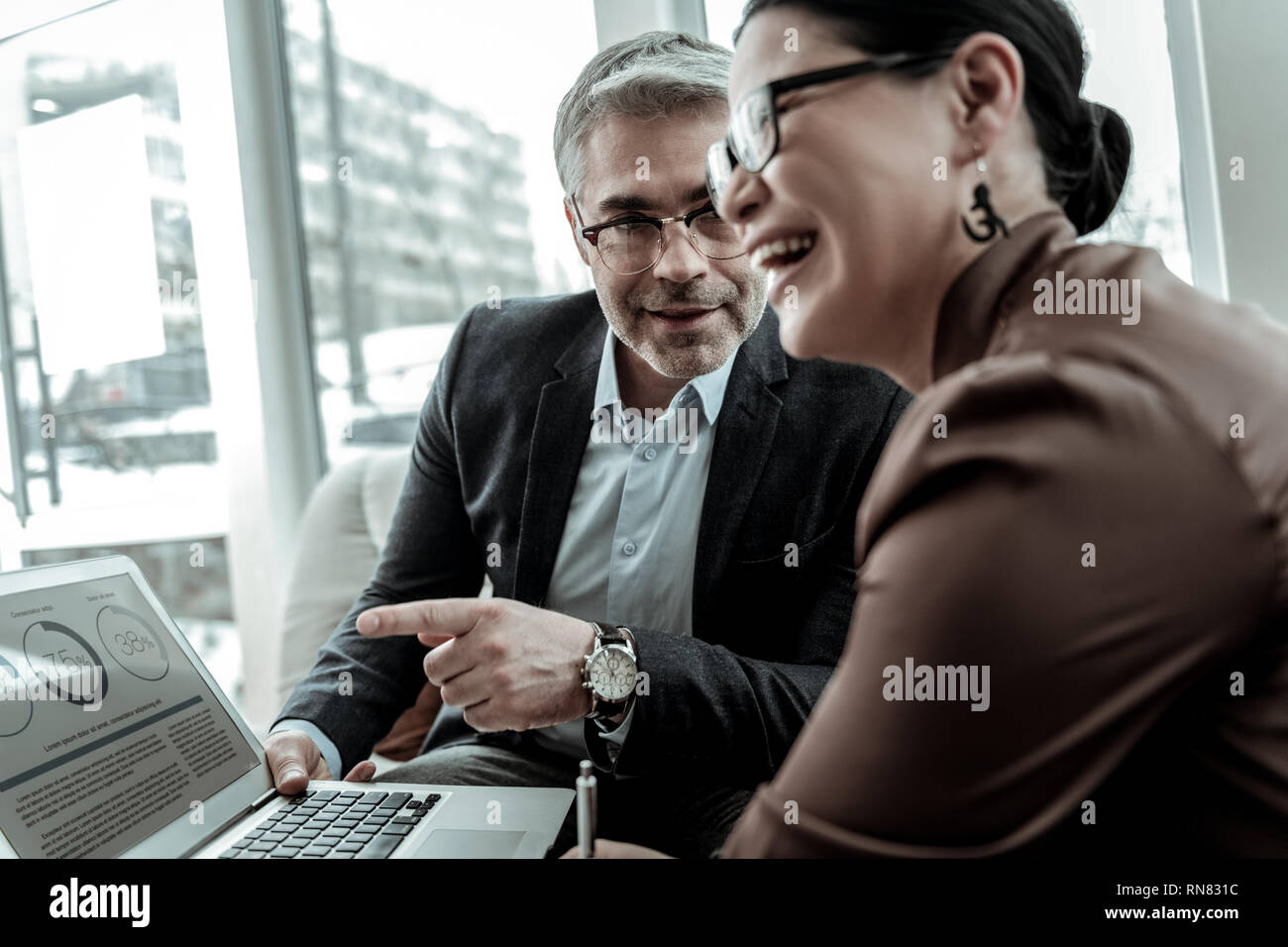 Tall grey-haired handsome man in a dark jacket and his partner having ...