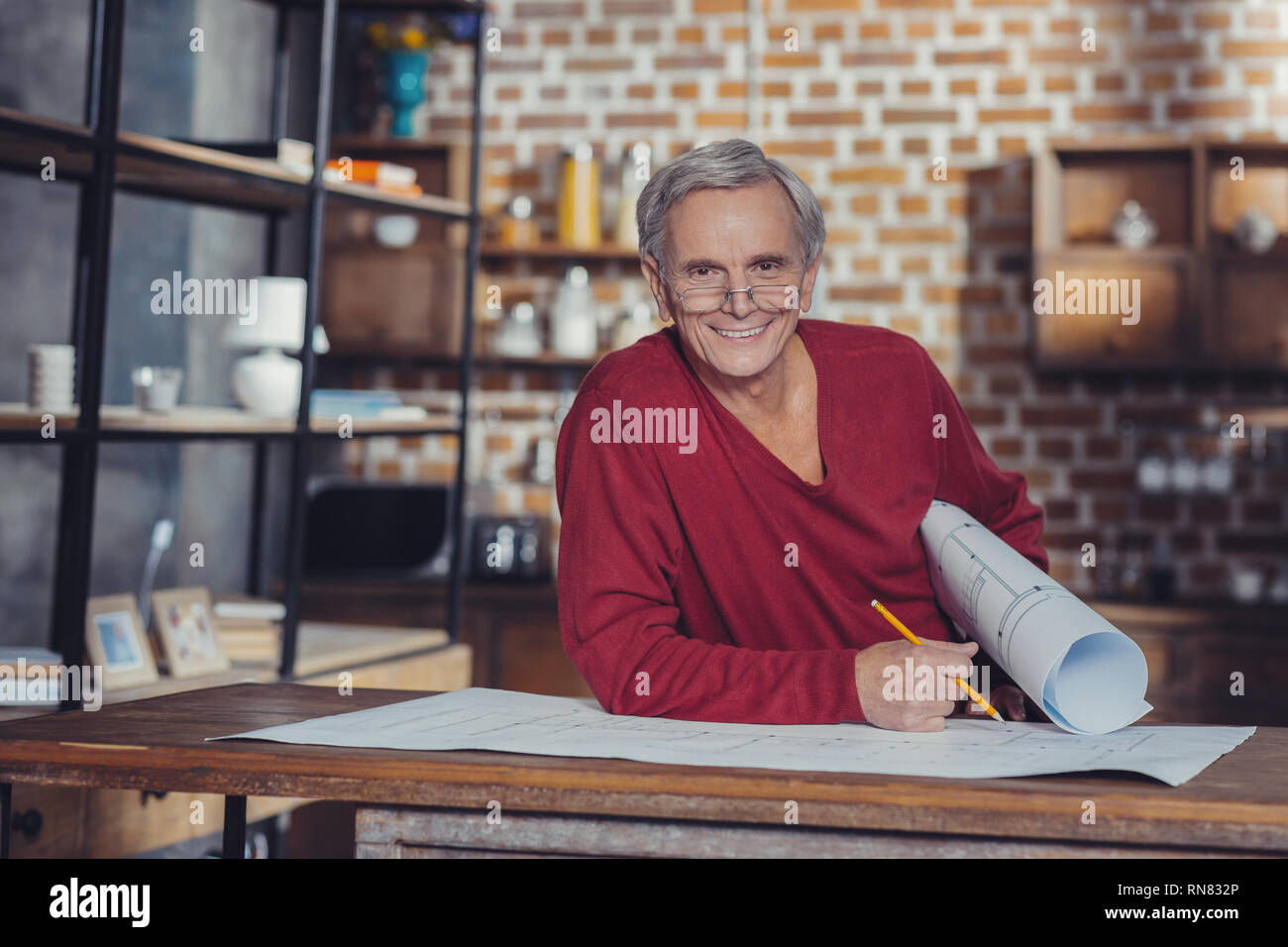 Smiling engineer. Cheerful emotional aged engineer smiling happily ...