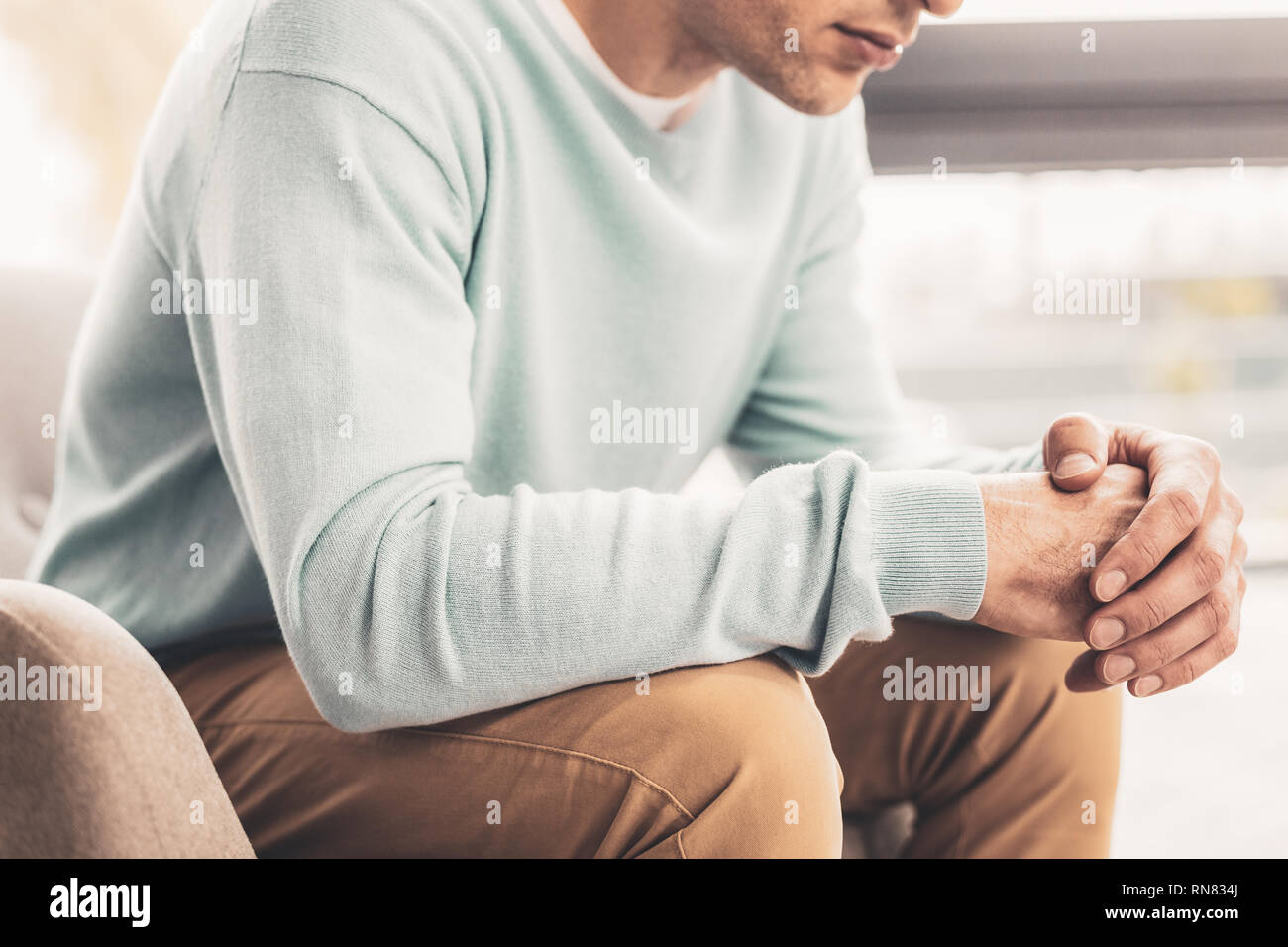 Bothered man. Bothered young man feeling terrible while having ...