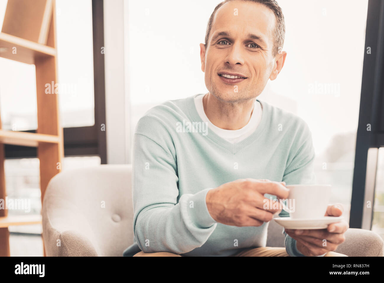 Lunch break. Famous successful business man smiling while having long ... Lunch break. Famous successful business man smiling while having long ...