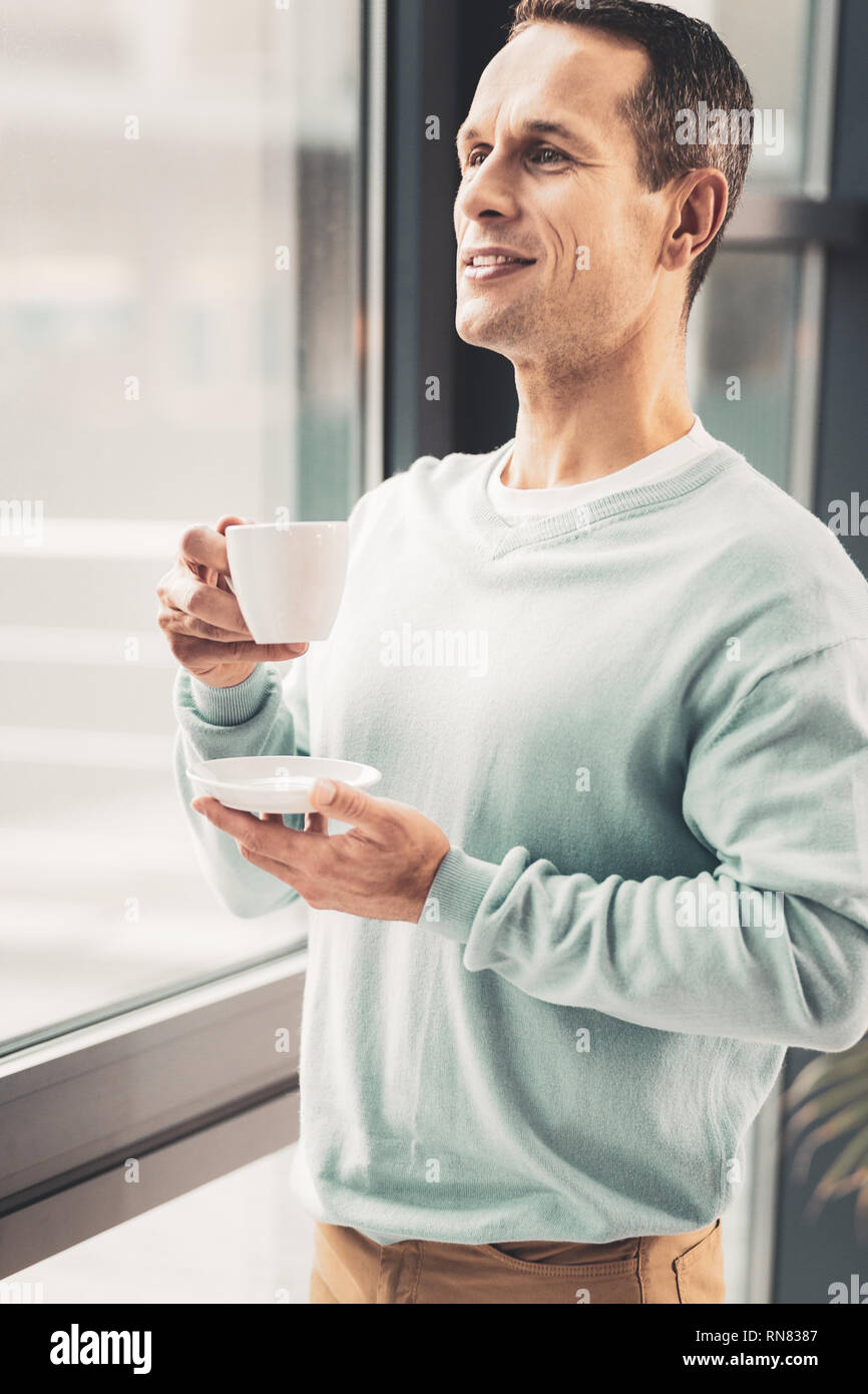 Inspired man. Successful business man feeling very inspired while ...