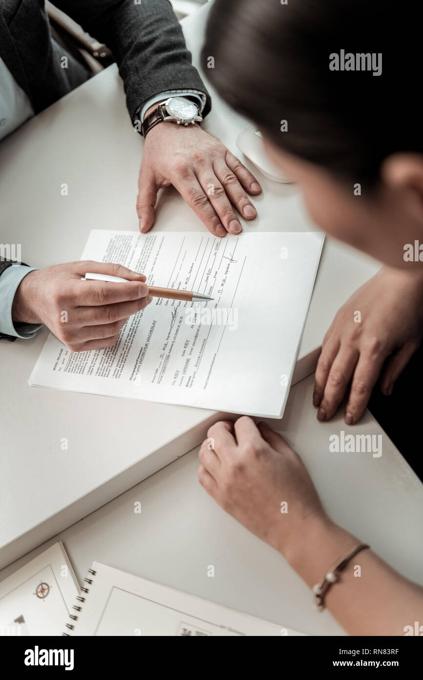 Man with a watch on his hand showing the job offer to the employee ...