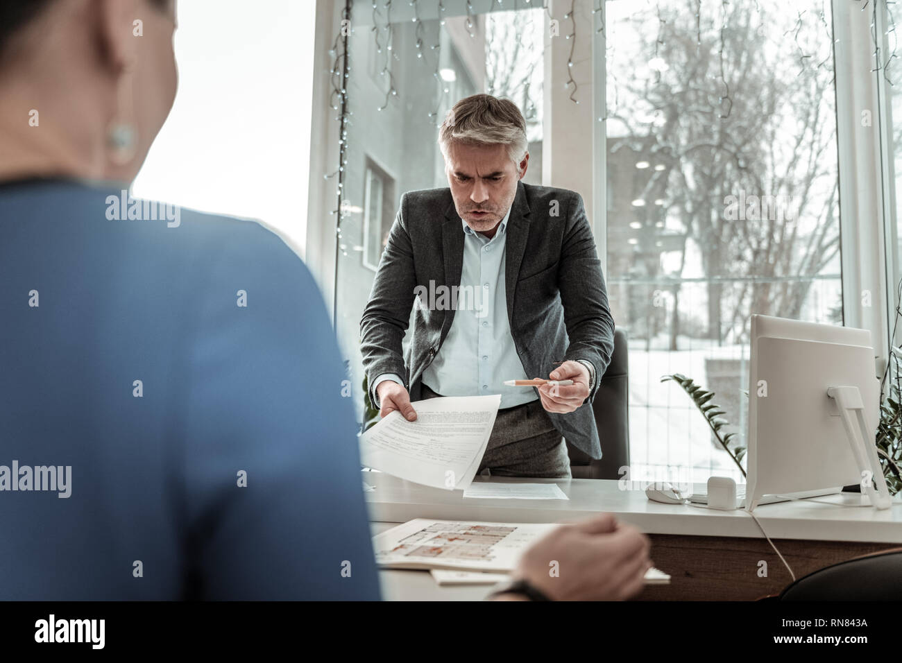 Tall grey-haired handsome man in eyeglasses looking angry Stock Photo ...