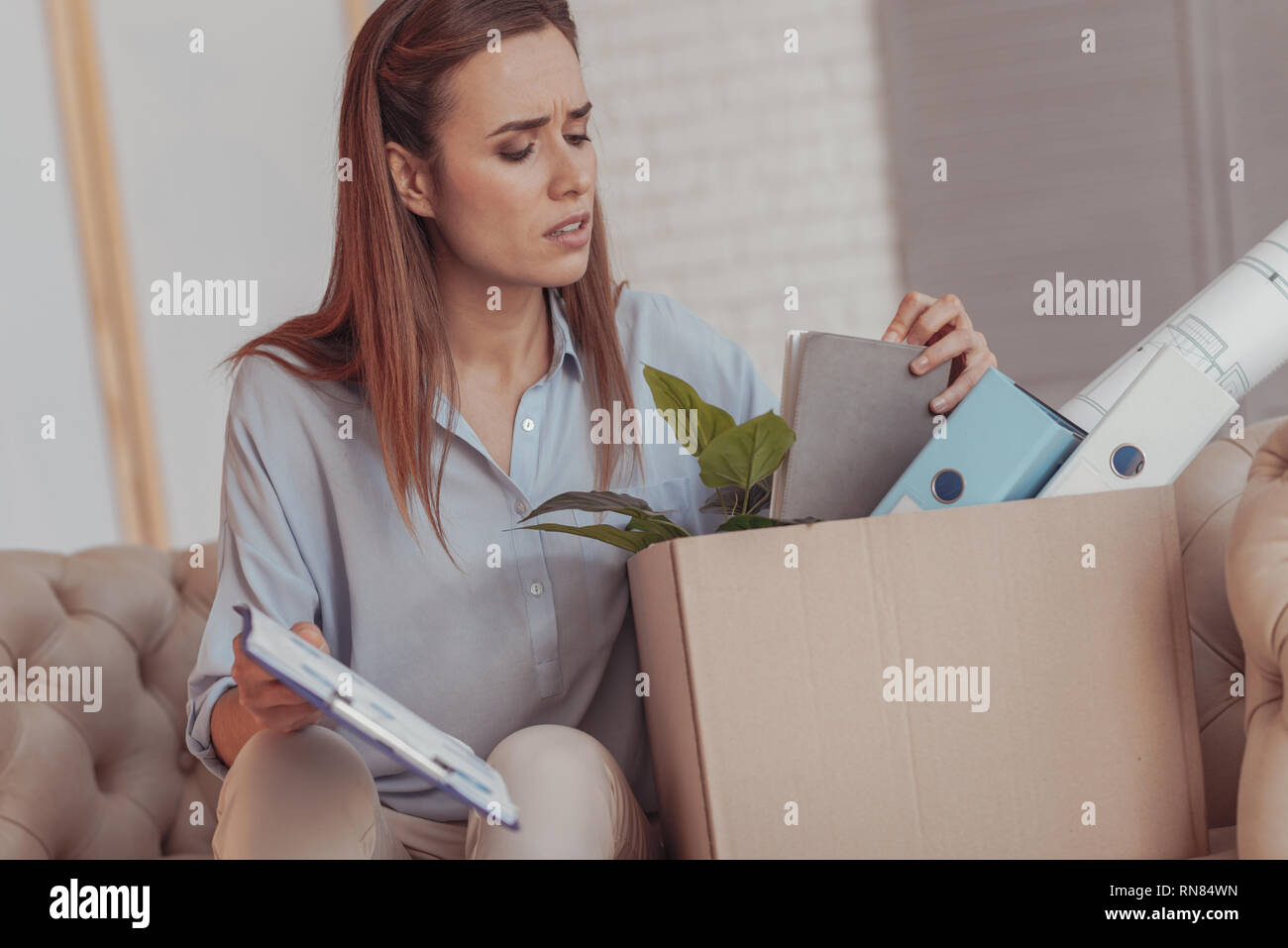 What a mess. Portrait of young nervous upset woman being concentrated ...