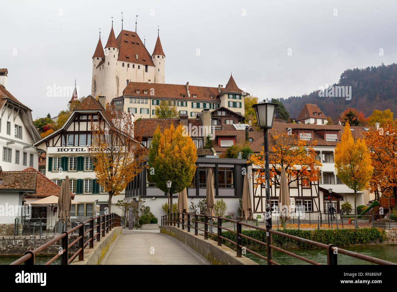 City view of Thun, with old and historical houses next to river Aare ...