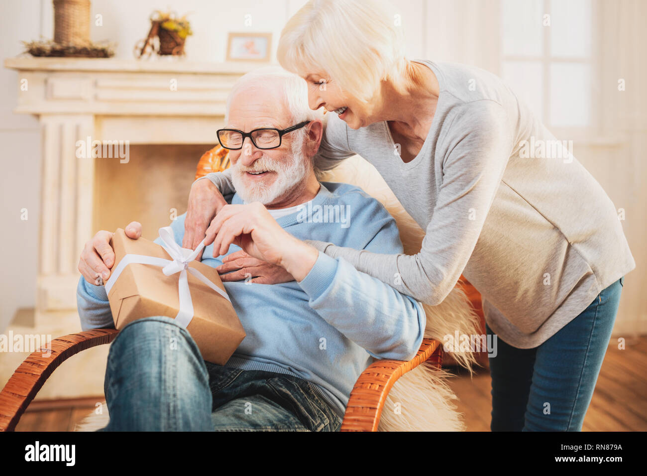 Unpacking present. Caring loving wife feeling helpful while helping her ...