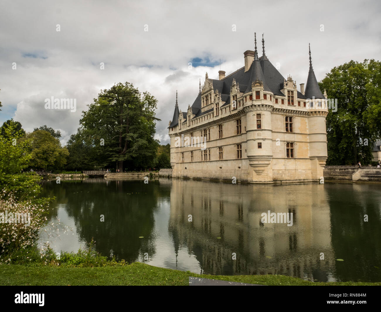Chateau d'Azay-le-Rideau sits on the reflective Indre River, in Loire ...