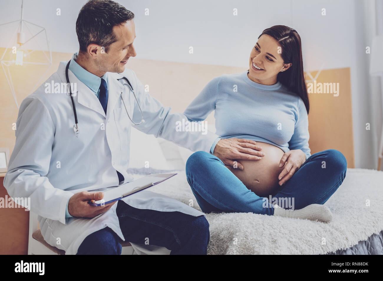 Let me check. Competent gynecologist holding folder in right hand while ...
