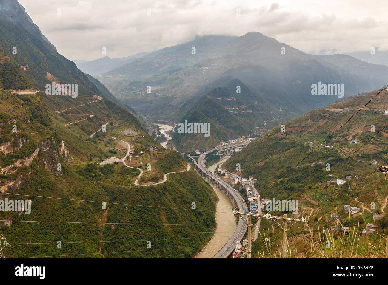 highway passes in a gorge in the mountains along the river, Heng River ...