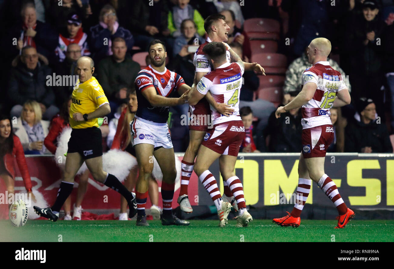 Wigan Warriors' Tom Davies (top) celebrates scoring a try with team ...