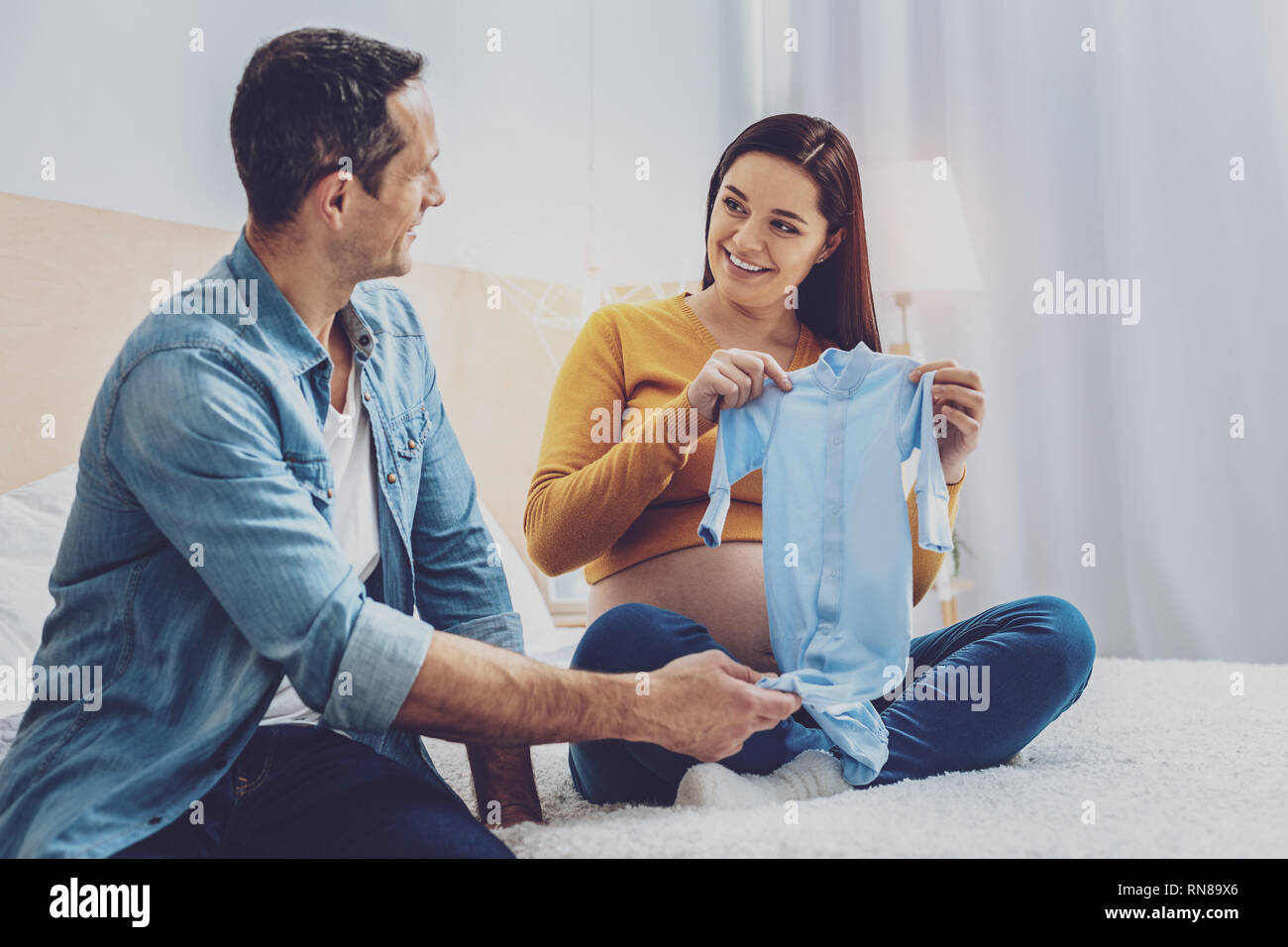 Expecting boy. Attractive pregnancy feeling happiness while looking at ...