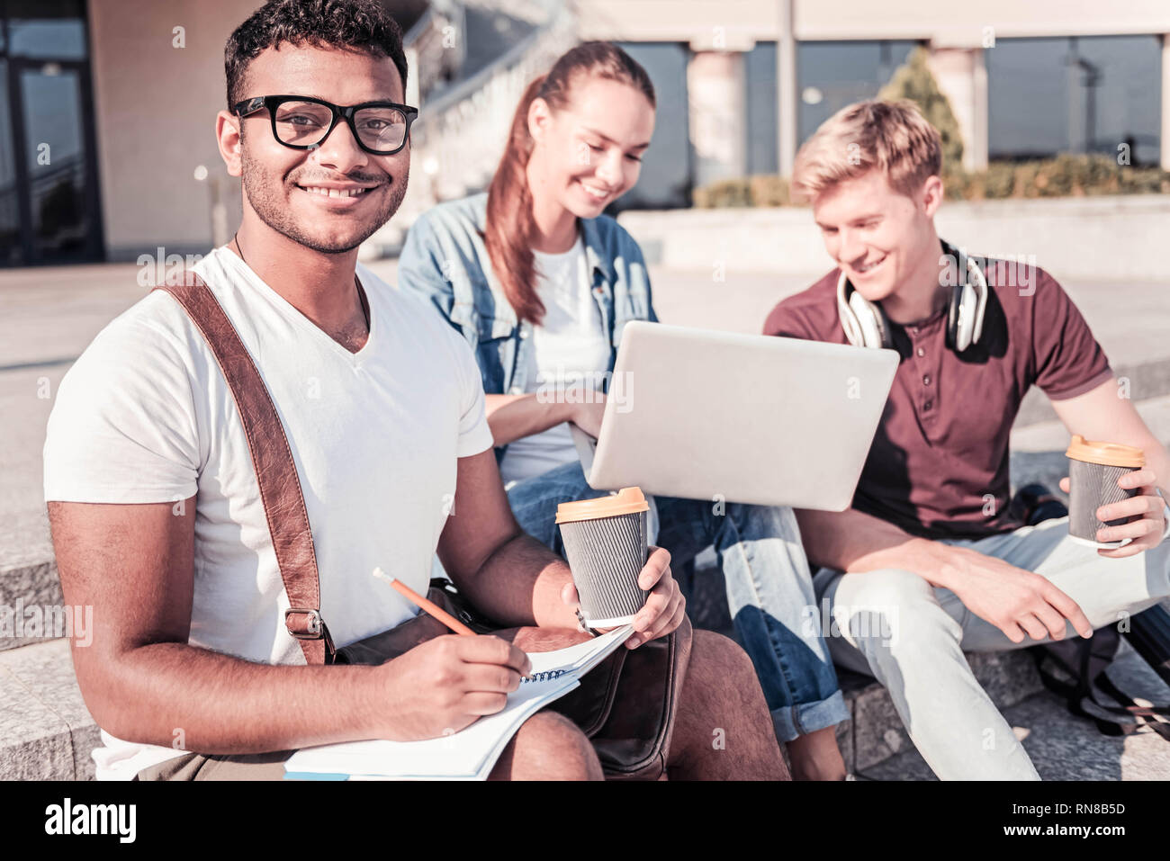 My friends. Portrait of attractive foreigner that keeping smile on his ...