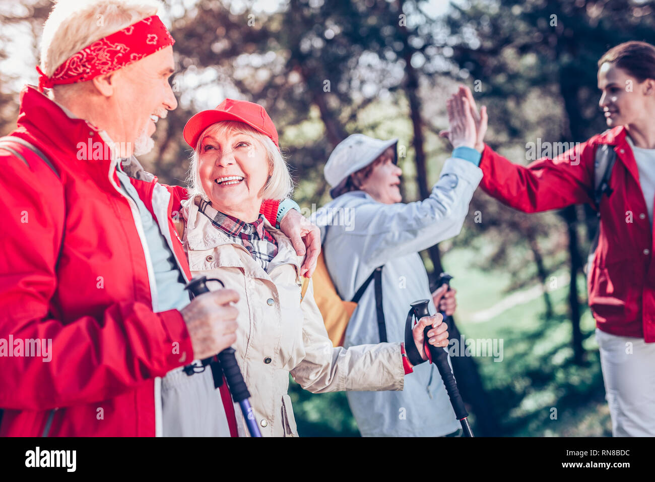 Hugging wife. Bearded retired man hugging his lovely appealing lady ...