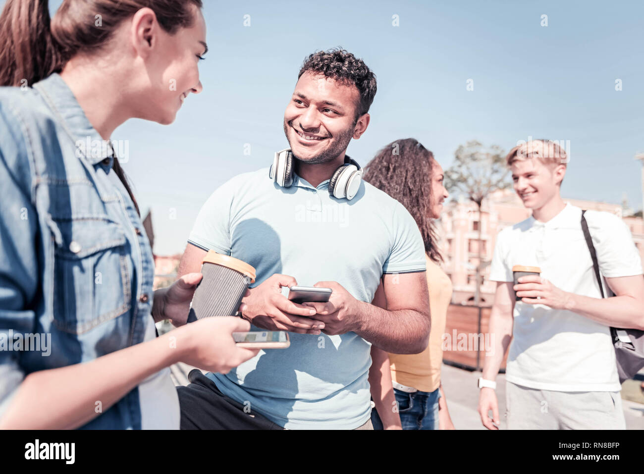 Call me later. Friendly colleagues expressing positivity and holding ...