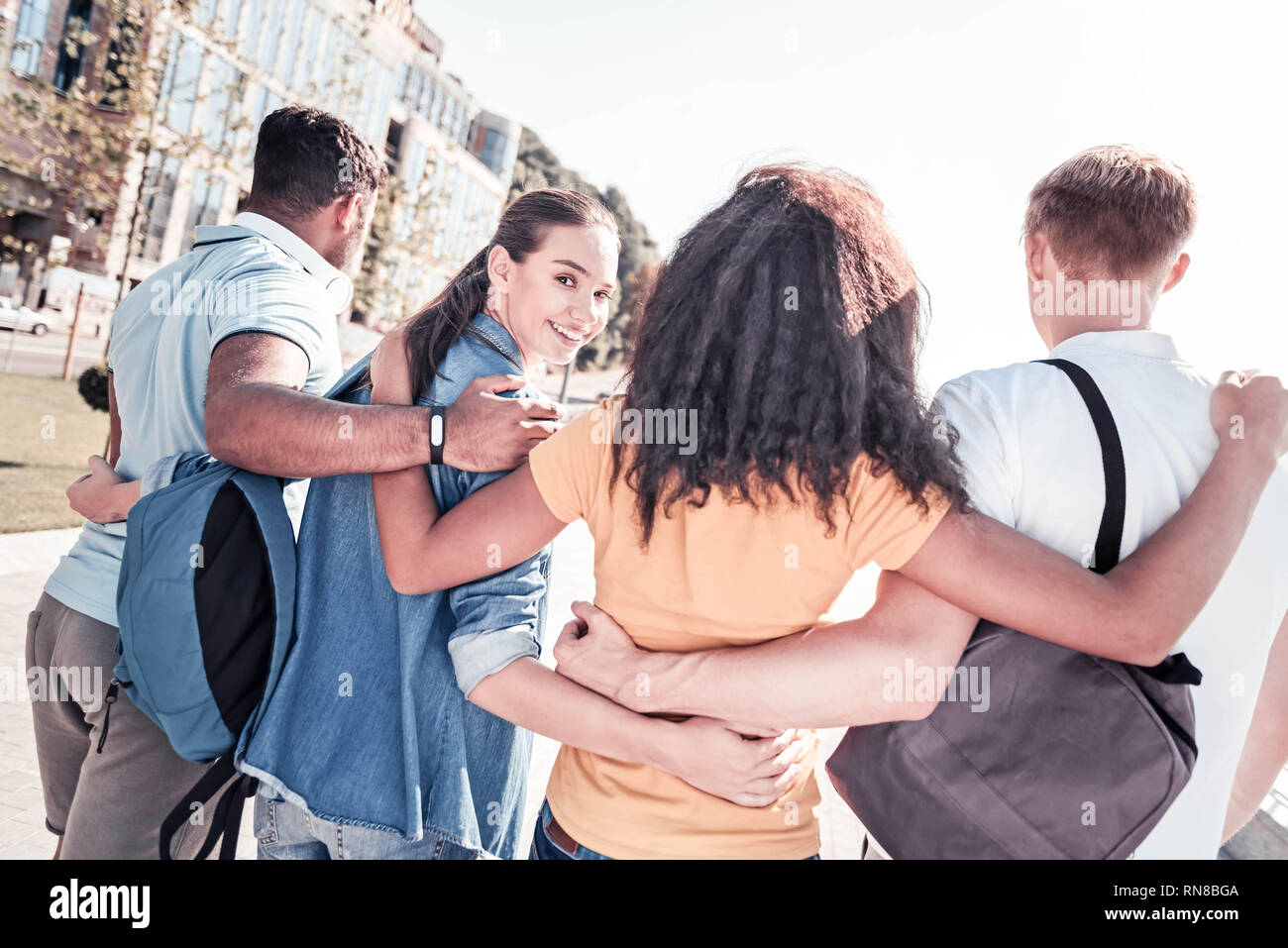 See you. Charming girl keeping smile on her face and embracing her ...