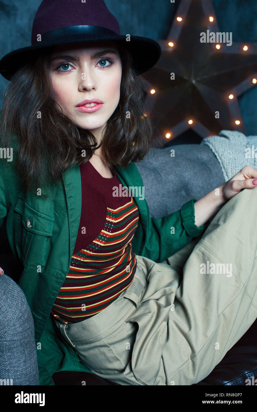 young pretty woman waiting alone in modern loft studio, fashion ...