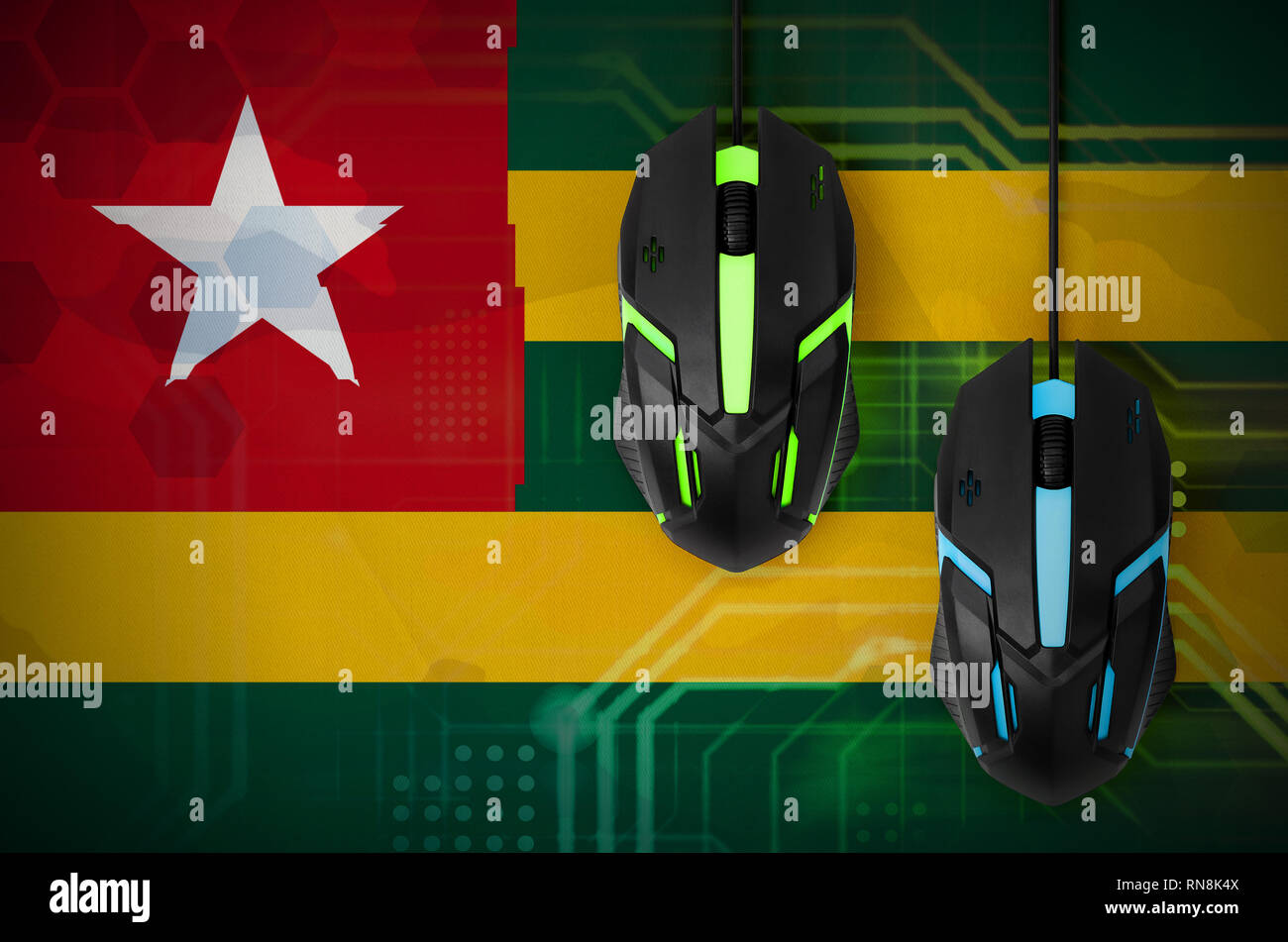 Togo flag and two modern computer mice with backlight. The concept of ...