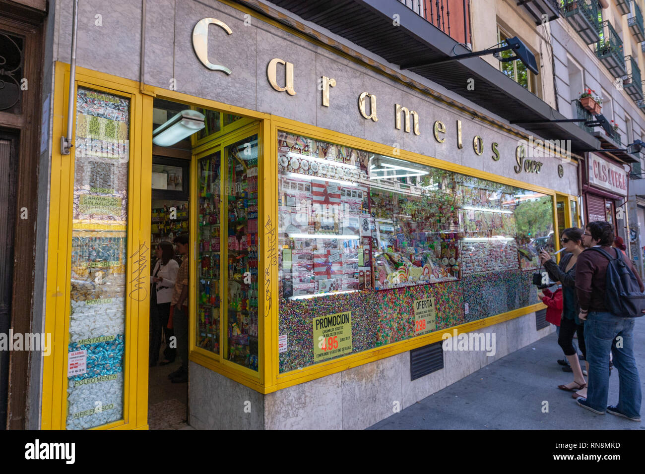 Family looking the showcase of the traditional Caramelos Paco, Sweet ...
