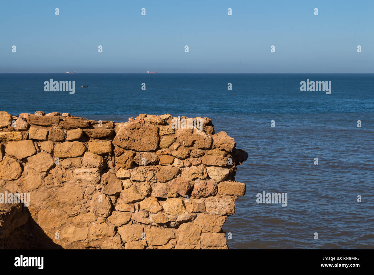 Parts of the stone wall at the cliffs of the Atlantic ocean. Former ...
