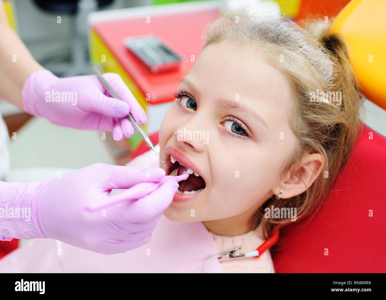the child is a sweet little girl without front milk teeth in the dental ...