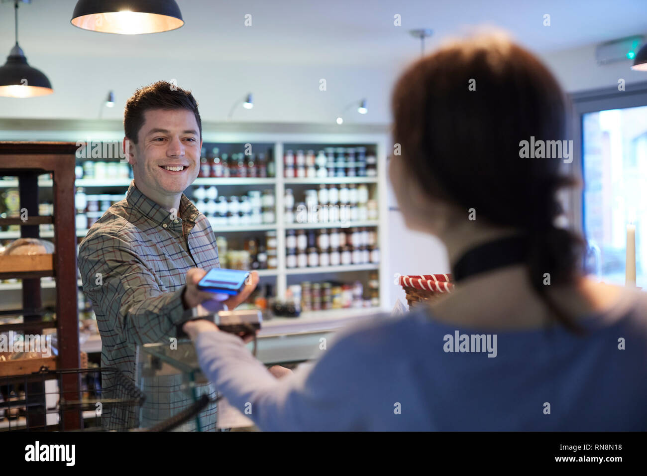 Sales man helping customer in store hi-res stock photography and images ...