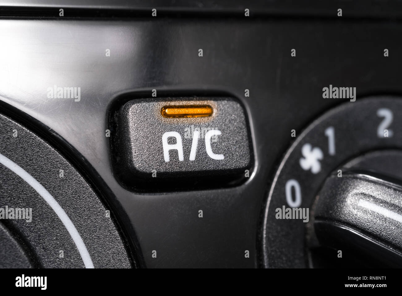 Closeup of car air conditioning (AC) button with orange light Stock ...