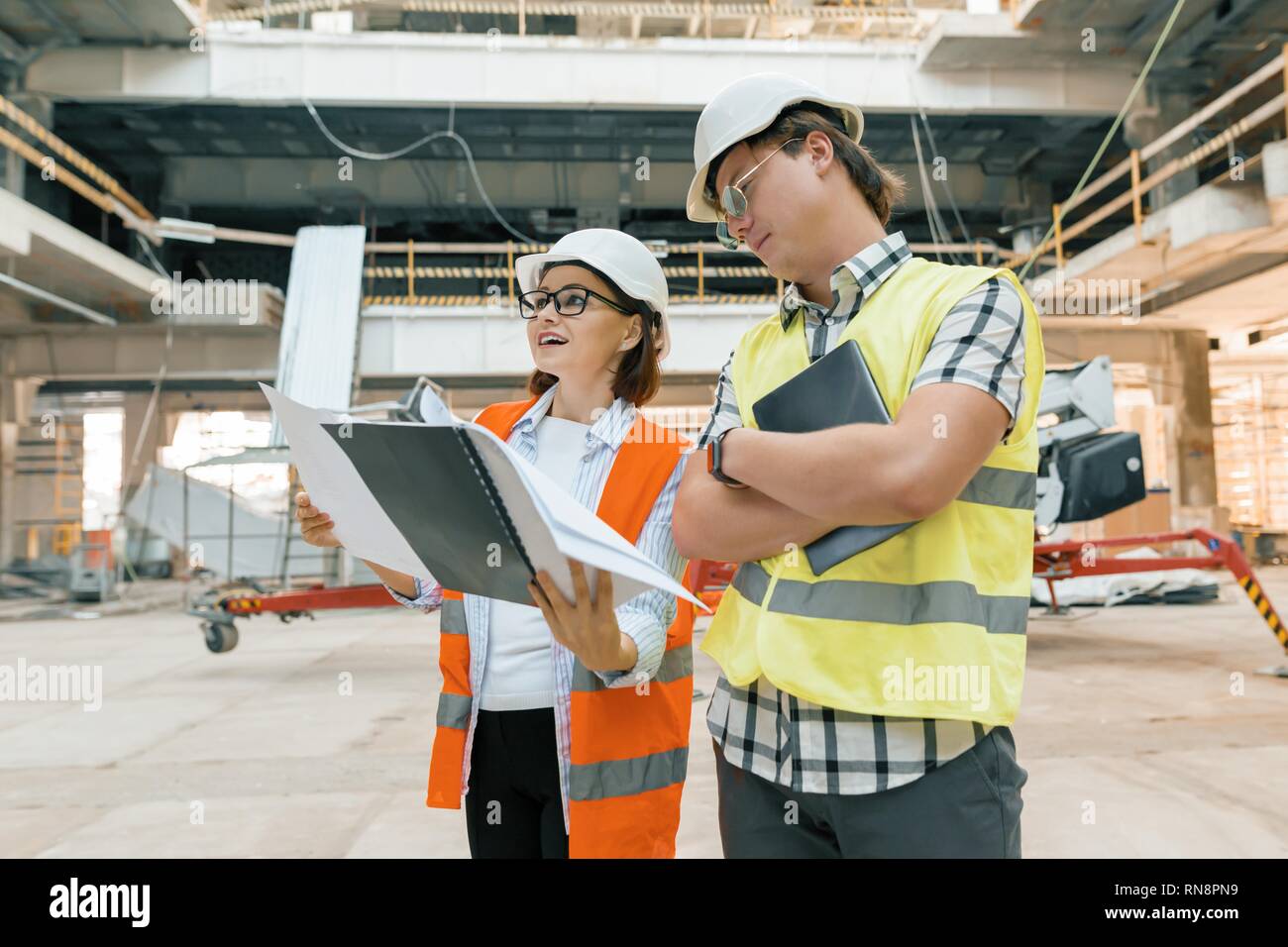 Female construction inspector examining construction site. Building ...