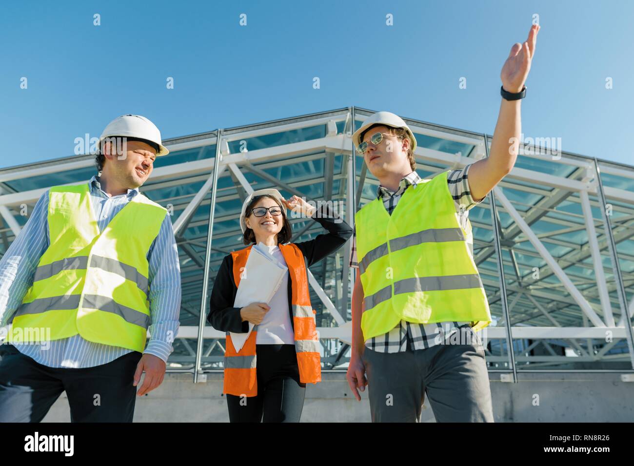 Team of builders engineer architect on the roof of construction site ...