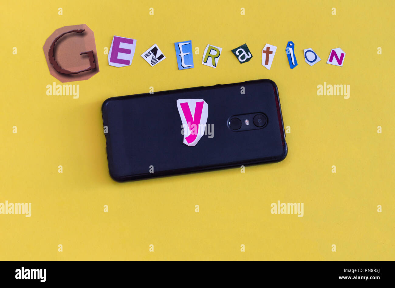 Word Generation Y Formed With Cut Letters And A Smarthphone Concept Of The Revolutionary